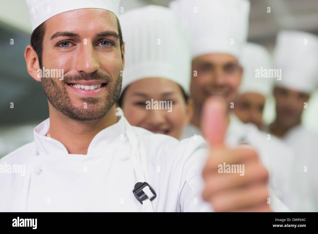 Happy team of chefs standing in line Stock Photo - Alamy