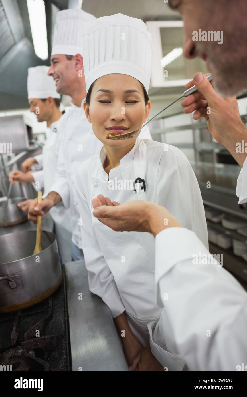 Head chef smelling a spoon of soup Stock Photo - Alamy