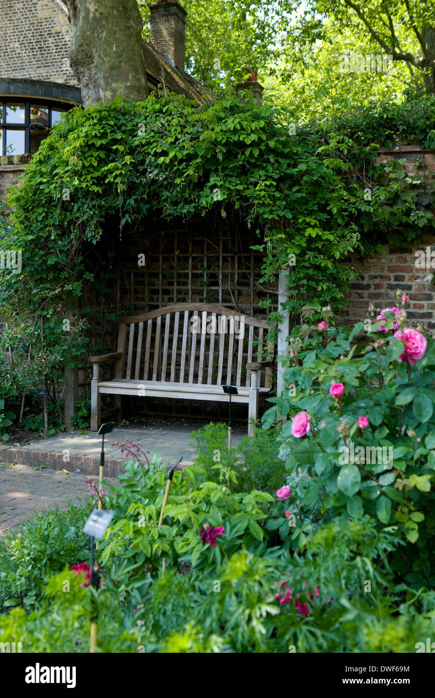 Wood bench under an arbor in the Geffrye Museum's herb garden ...