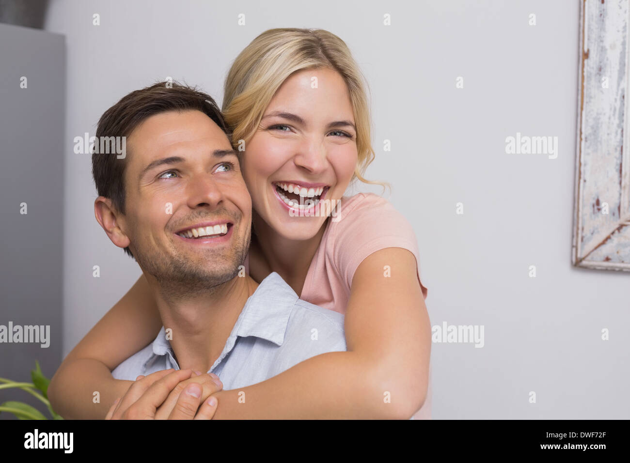 Couple hugging from behind laughing hi-res stock photography and images ...
