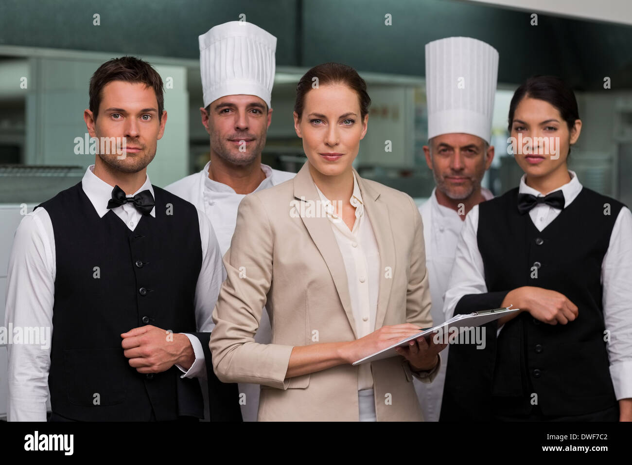 Restaurant team posing together looking at camera Stock Photo - Alamy