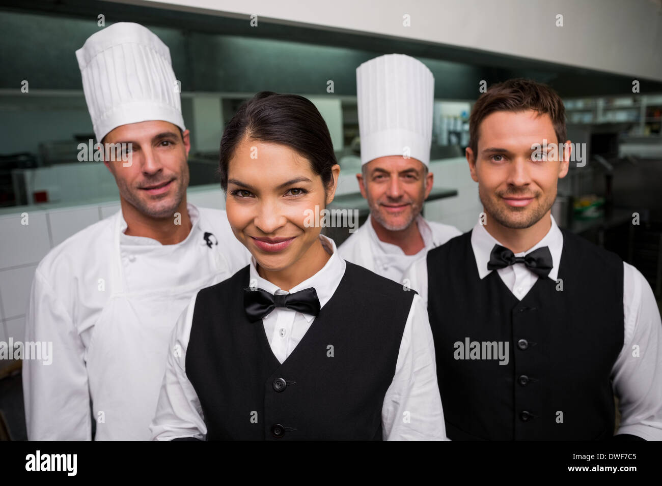 Restaurant team posing together looking at camera Stock Photo - Alamy