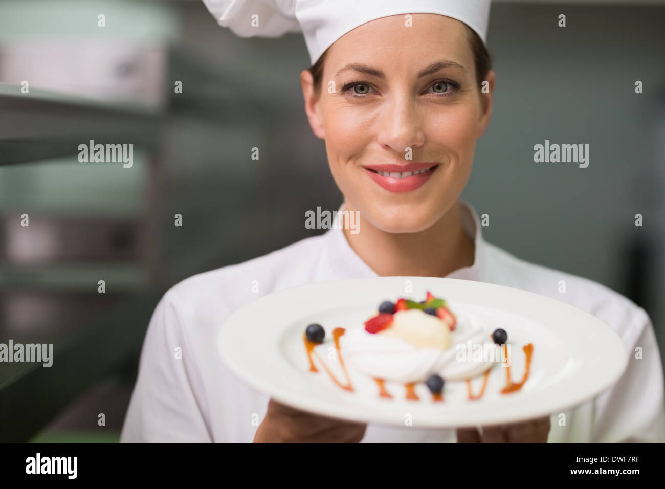 Smiling female chef plate hi-res stock photography and images - Alamy