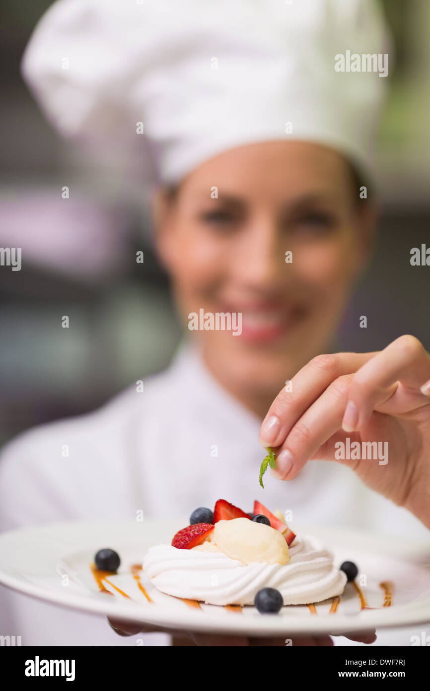 Happy chef smiling at camera holding dessert plate Stock Photo - Alamy