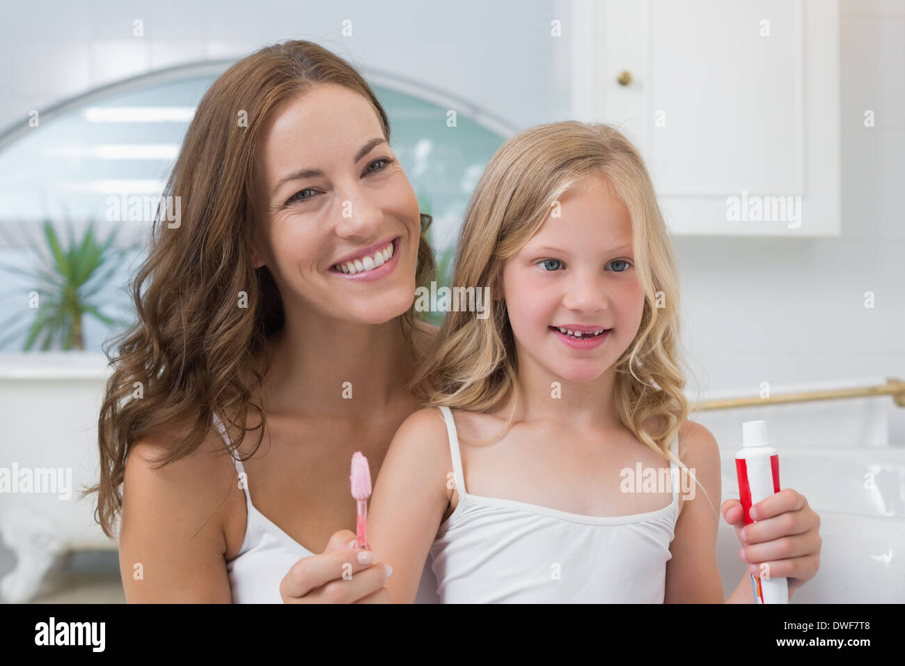 Mother and daughter with toothbrush and toothpaste Stock Photo - Alamy