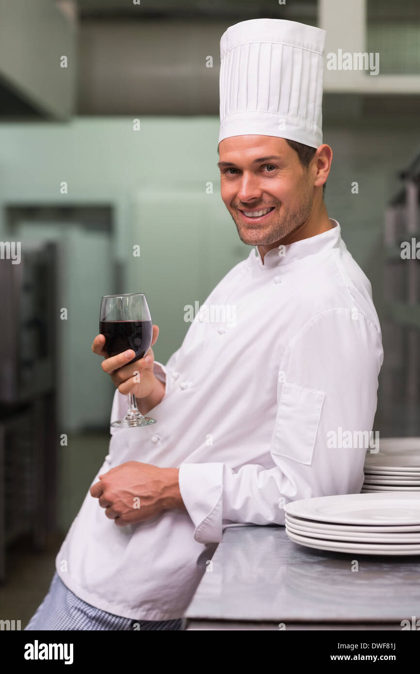 Chef relaxing with glass of red wine after work Stock Photo - Alamy