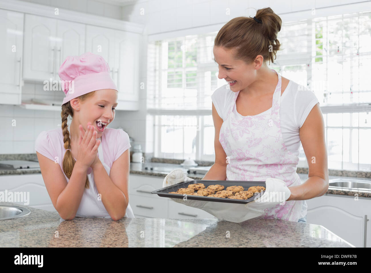 Child girl holding cookie smiling hi-res stock photography and images ...