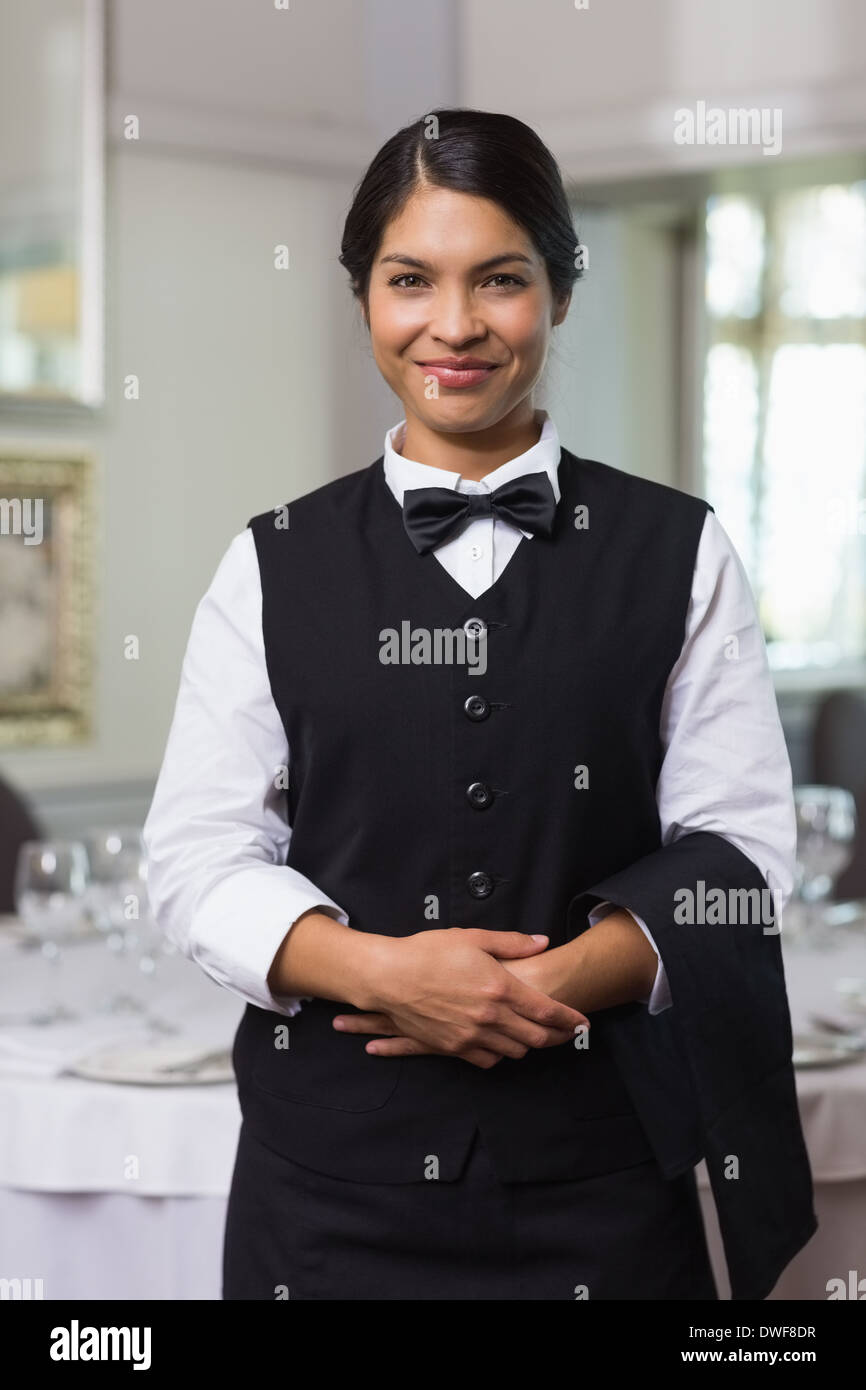 Pretty waitress smiling at the camera Stock Photo - Alamy