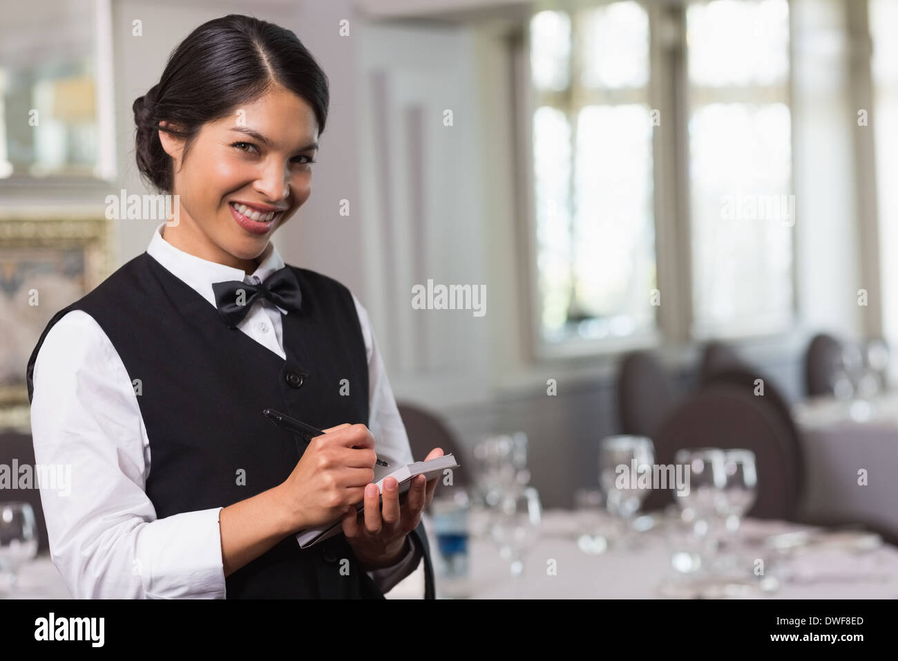 Pretty waitress taking an order Stock Photo - Alamy