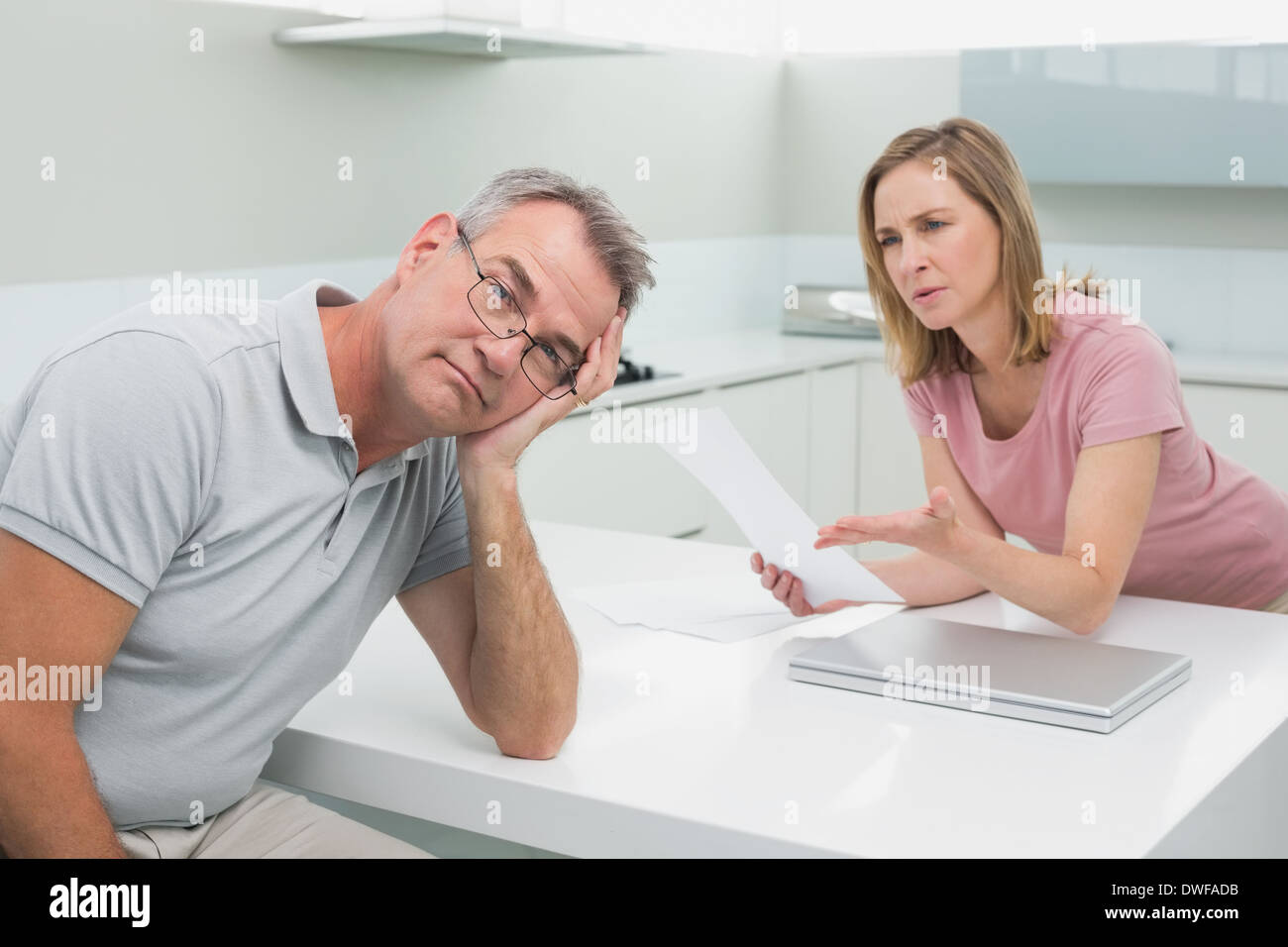 Couple having an argument over a bill in kitchen Stock Photo - Alamy
