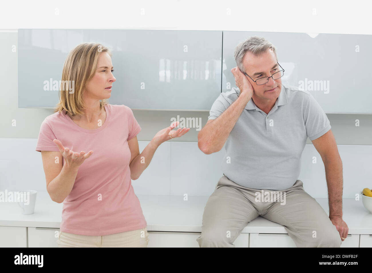 Couple having an argument in kitchen Stock Photo - Alamy