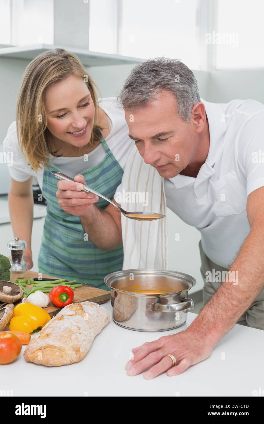 Couple preparing food together in kitchen Stock Photo - Alamy