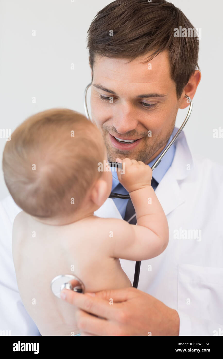 Pediatrician checking baby boy Stock Photo - Alamy