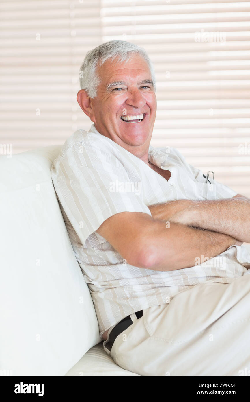 Happy senior man sitting on the couch Stock Photo - Alamy