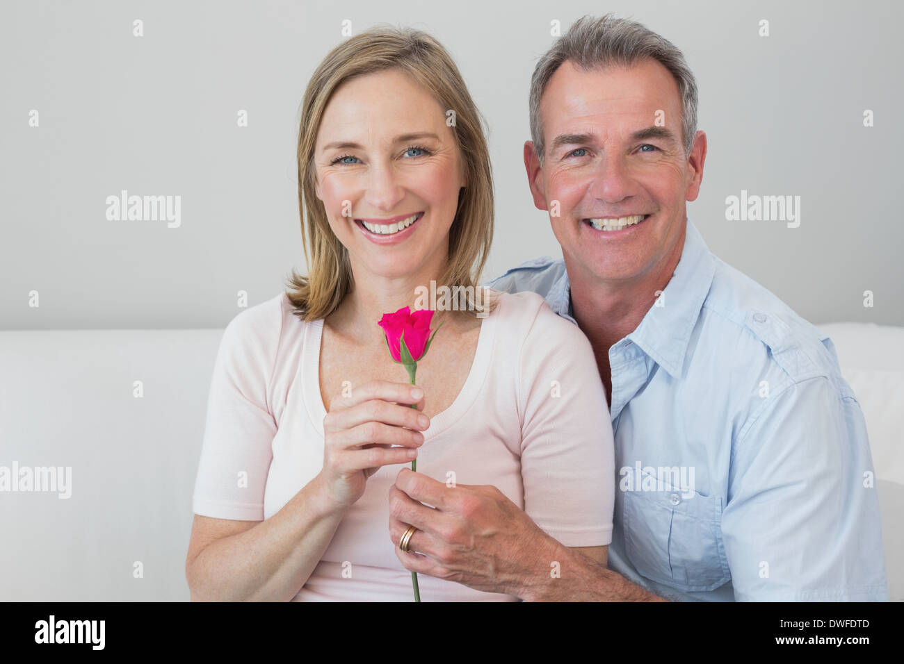 Happy romantic couple with a flower Stock Photo - Alamy