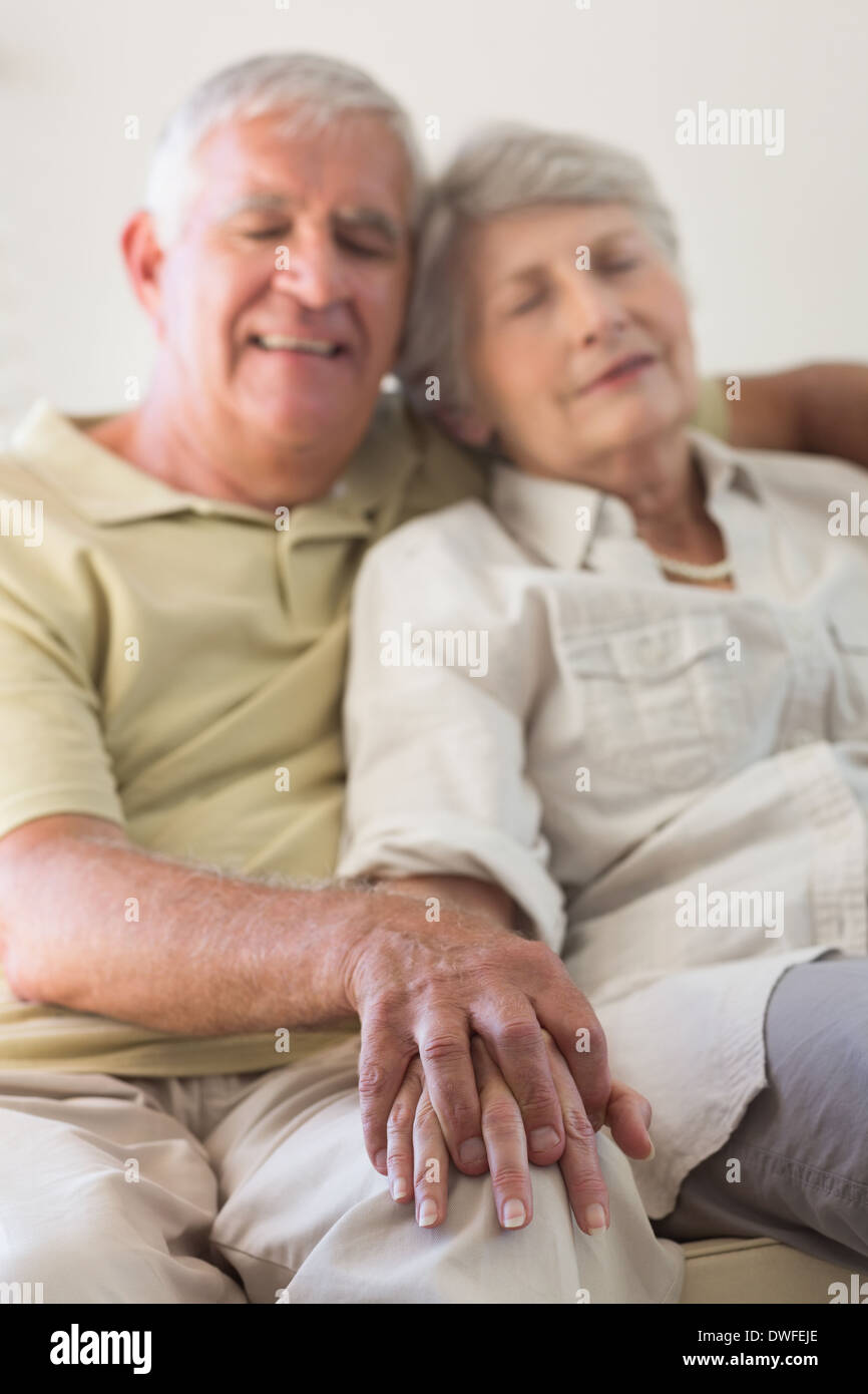 Senior couple napping on the couch Stock Photo - Alamy