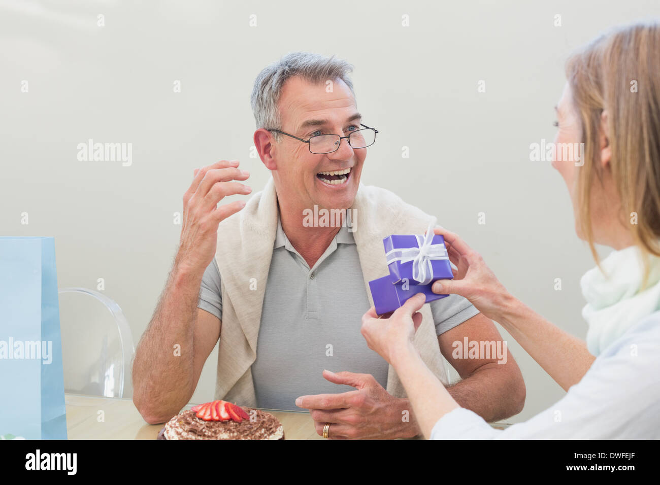 Cheerful man receiving a gift Stock Photo - Alamy