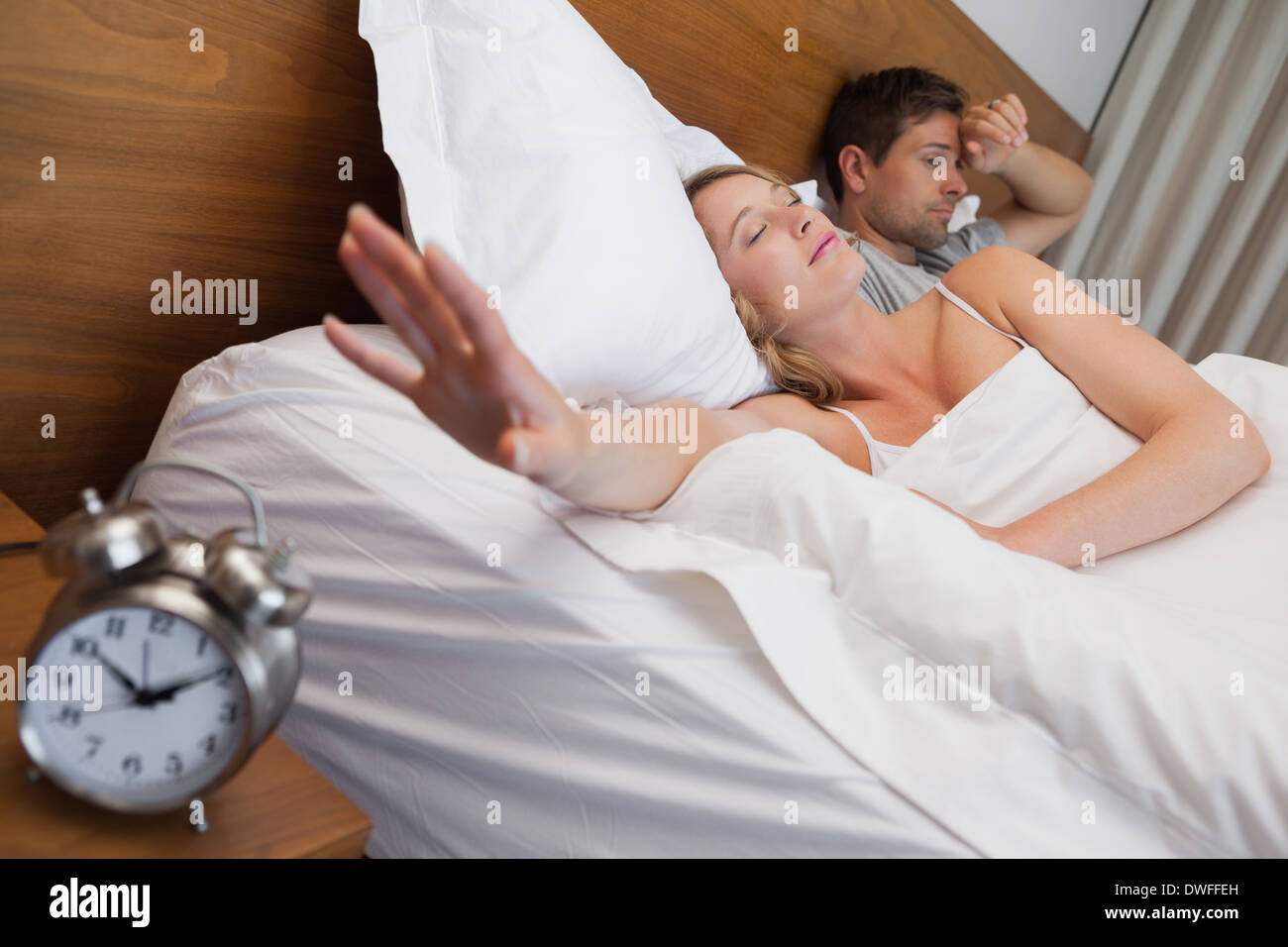 Couple bed alarm clock hi-res stock photography and images - Alamy
