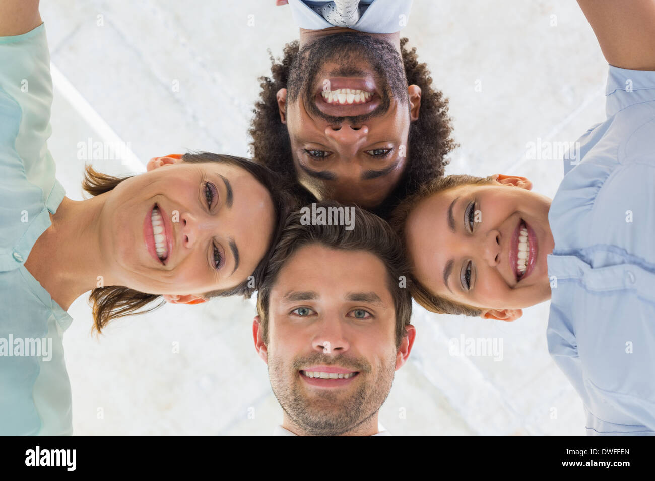 Business team forming a huddle Stock Photo - Alamy