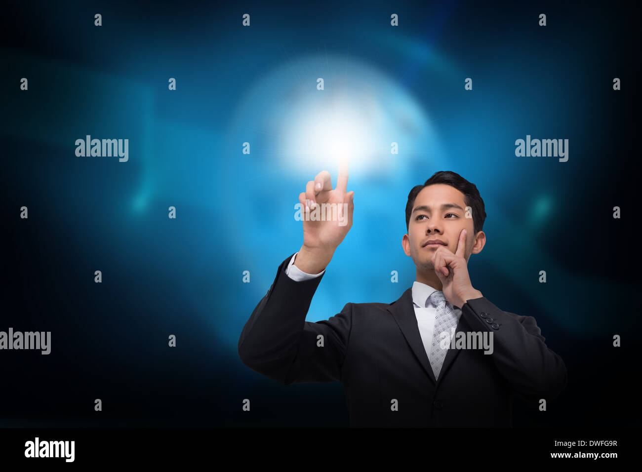 Asian businessman pointing to light Stock Photo - Alamy