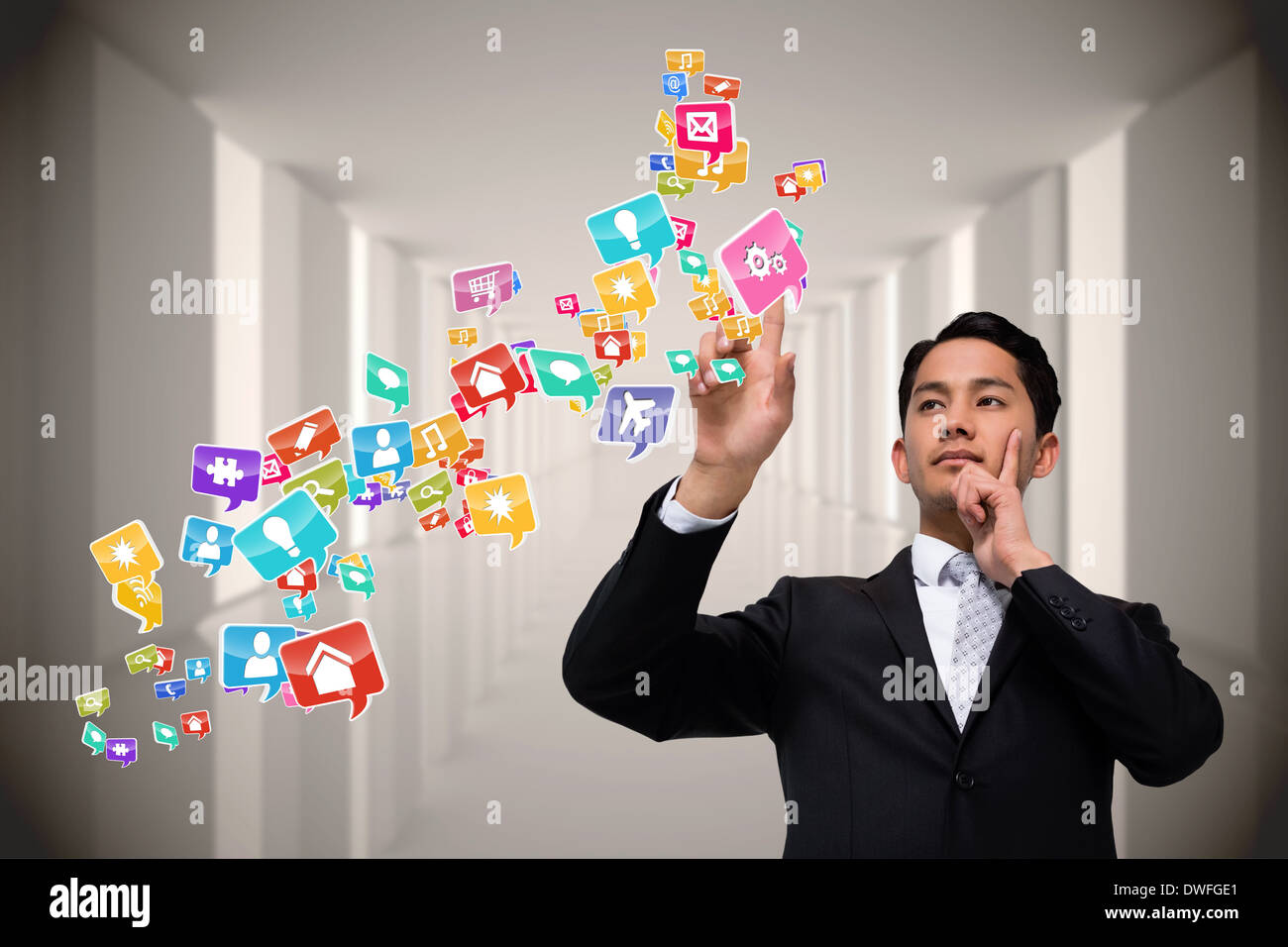 Asian businessman pointing to app icons Stock Photo - Alamy