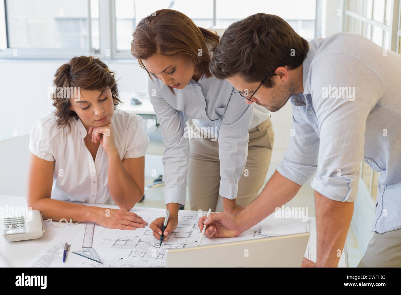 Business people working on blueprints at office Stock Photo - Alamy