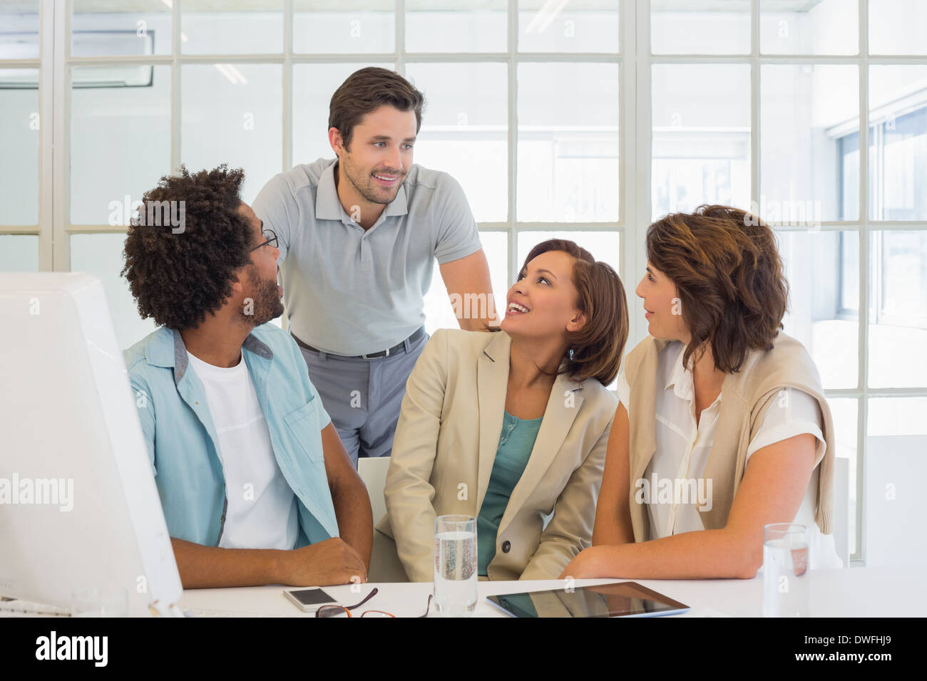 Business people having a conversation at office desk Stock Photo - Alamy