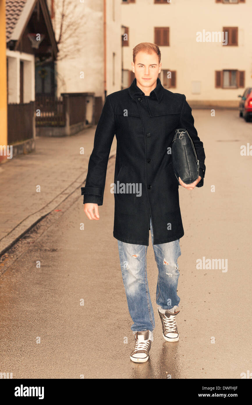 Confident stylish young man walking in town Stock Photo - Alamy
