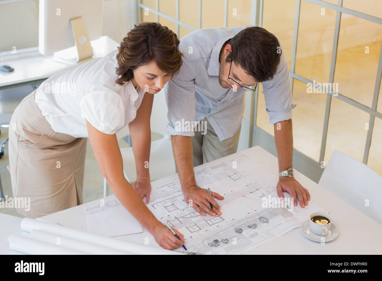 Business people working on blueprints at office Stock Photo - Alamy