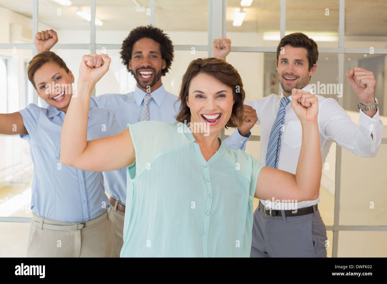 Cheerful business colleagues cheering in office Stock Photo - Alamy