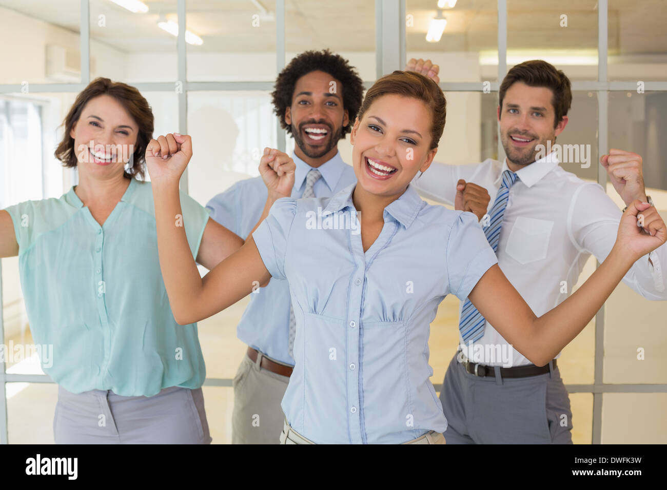 Cheerful business colleagues cheering in office Stock Photo - Alamy