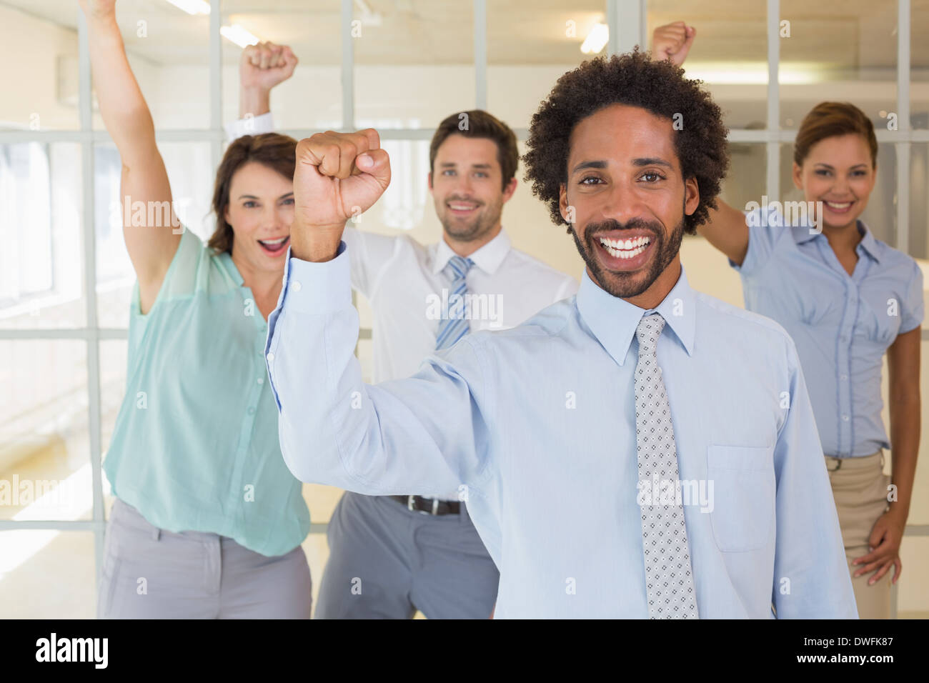 Cheerful business colleagues cheering in office Stock Photo - Alamy