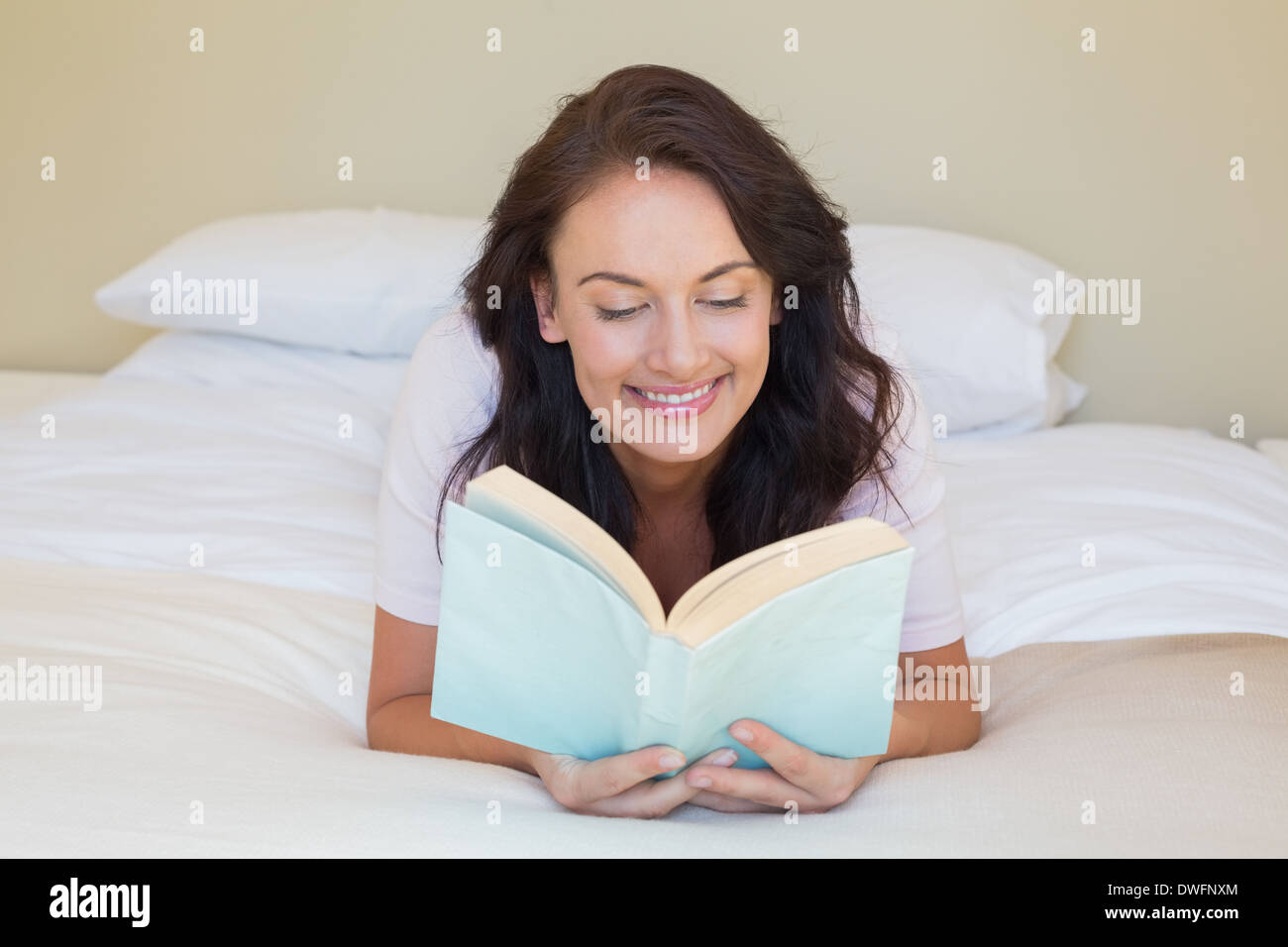 Brunette lying in bed reading hi-res stock photography and images - Alamy