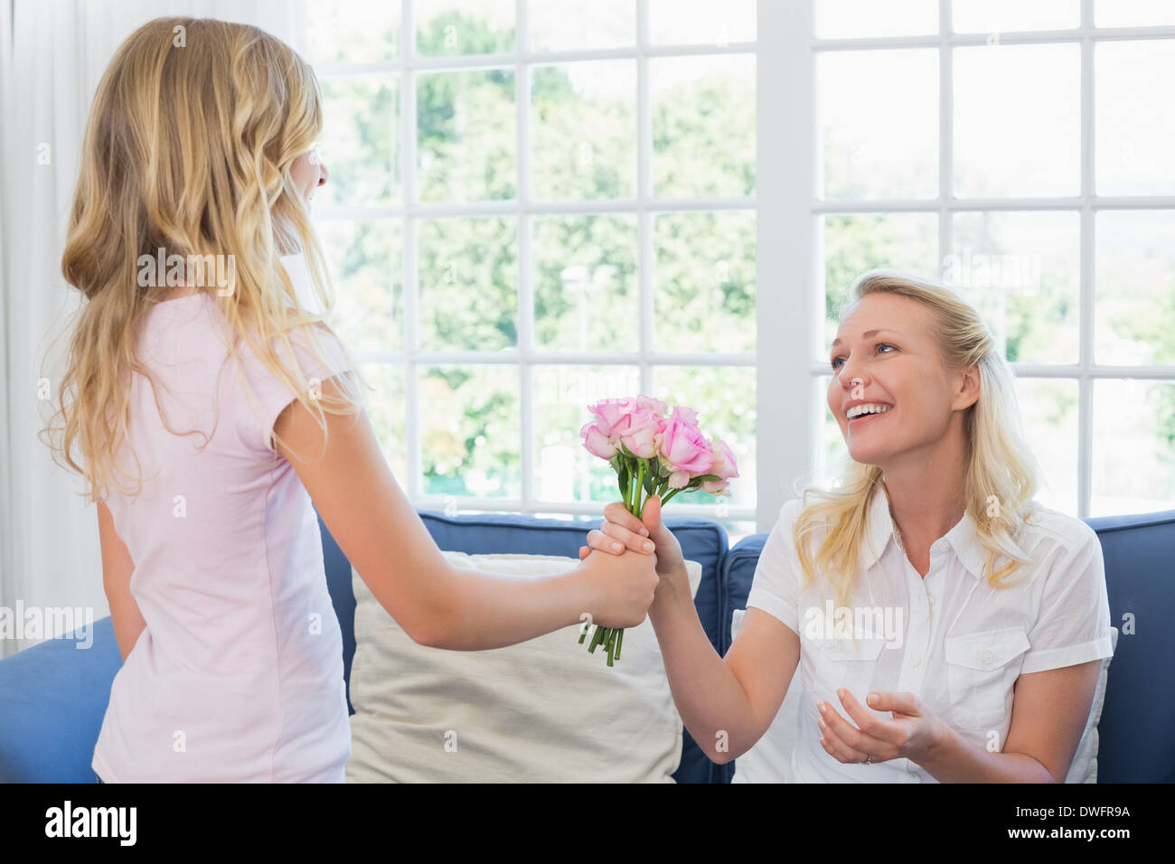 Mother receiving roses from loving daughter Stock Photo - Alamy