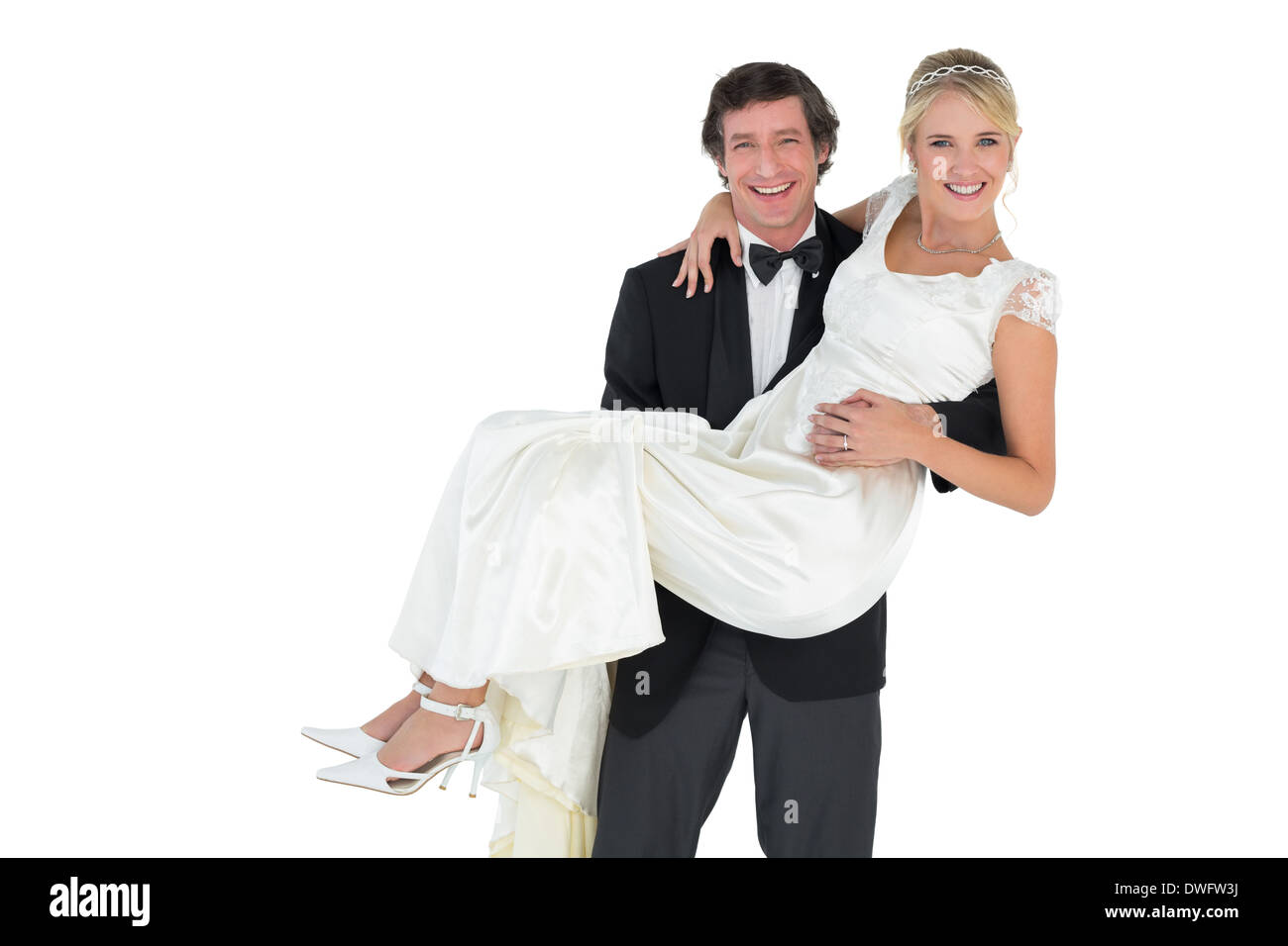 Handsome groom carrying bride Stock Photo - Alamy
