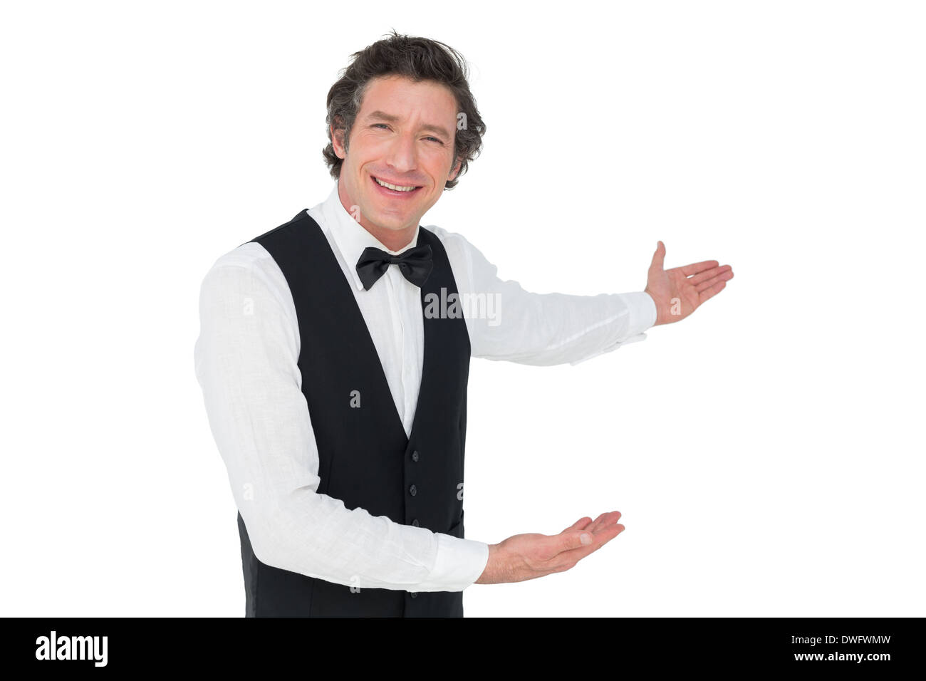 Happy waiter welcoming over white background Stock Photo - Alamy