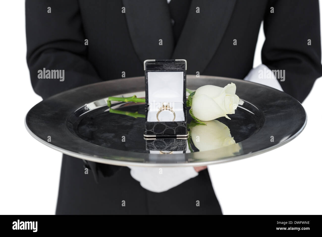 Mid section of waiter presenting engagement ring and rose Stock Photo ...