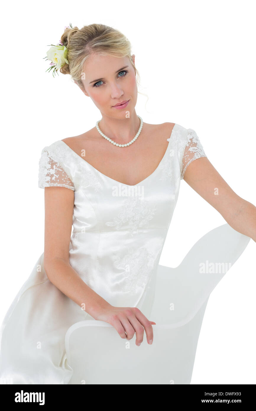 Attractive bride sitting on chair over white background Stock Photo - Alamy