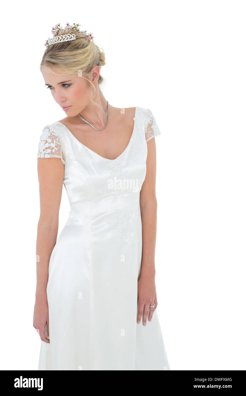 Thoughtful bride looking down over white background Stock Photo - Alamy