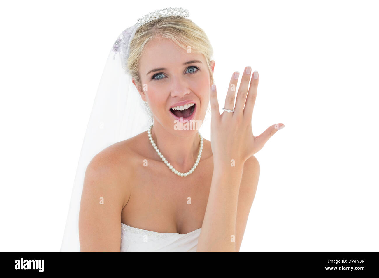 Surprised bride showing wedding ring over white background Stock Photo ...