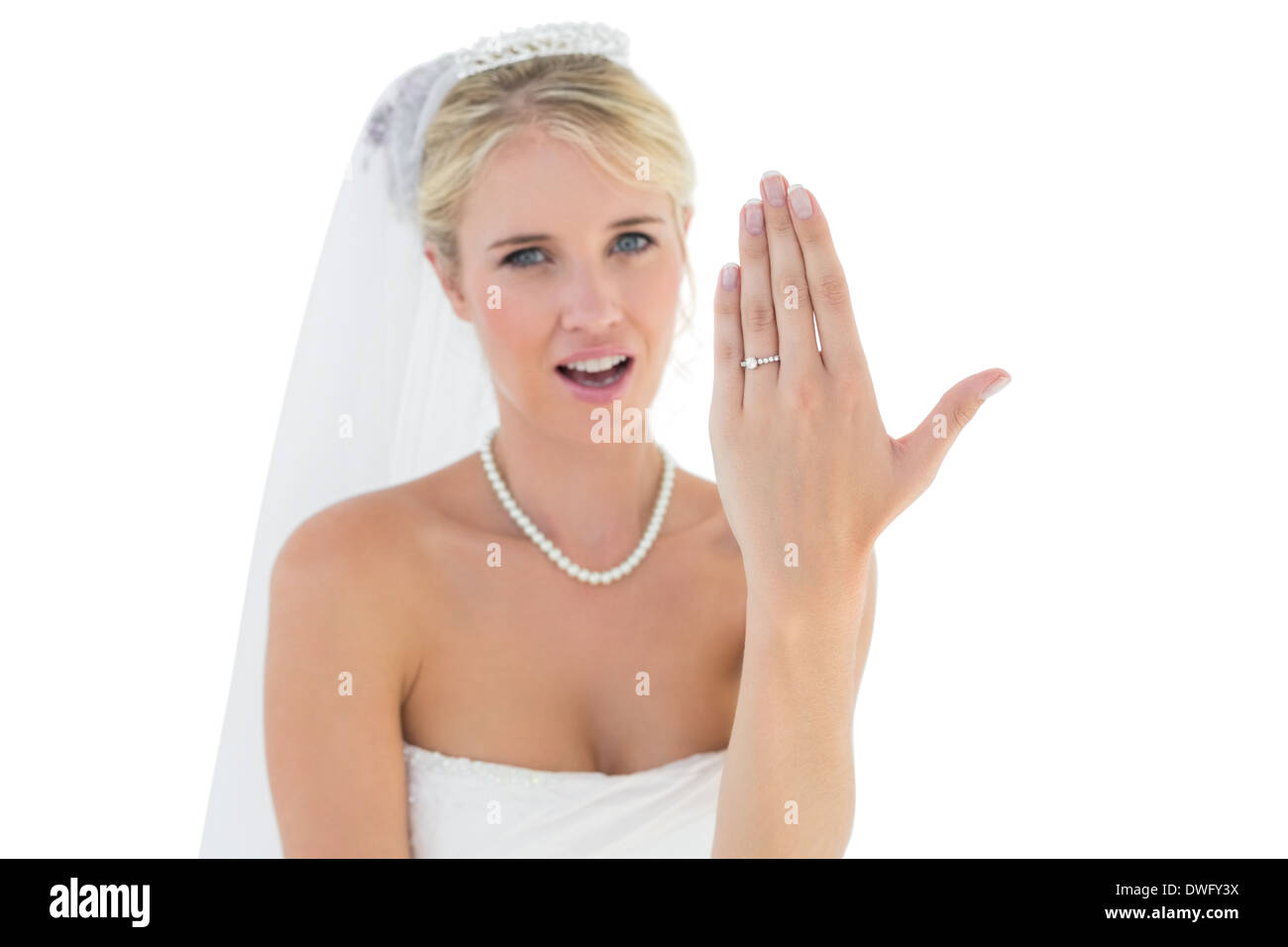 Surprised bride showing wedding ring against white background Stock ...