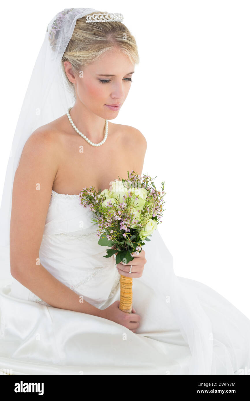 Thoughtful bride holding flower bouquet Stock Photo - Alamy