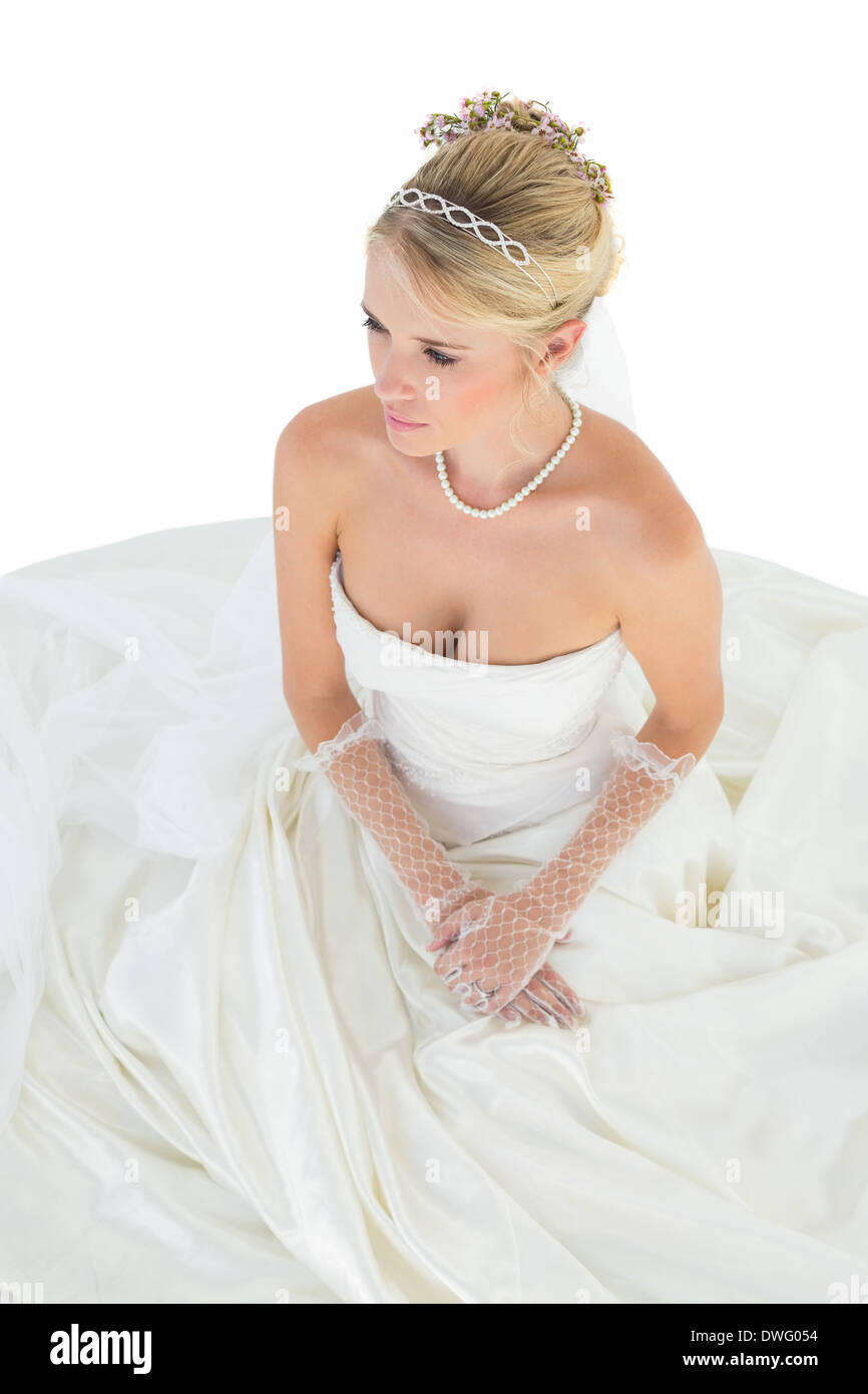Bride thinking while sitting over white background Stock Photo - Alamy