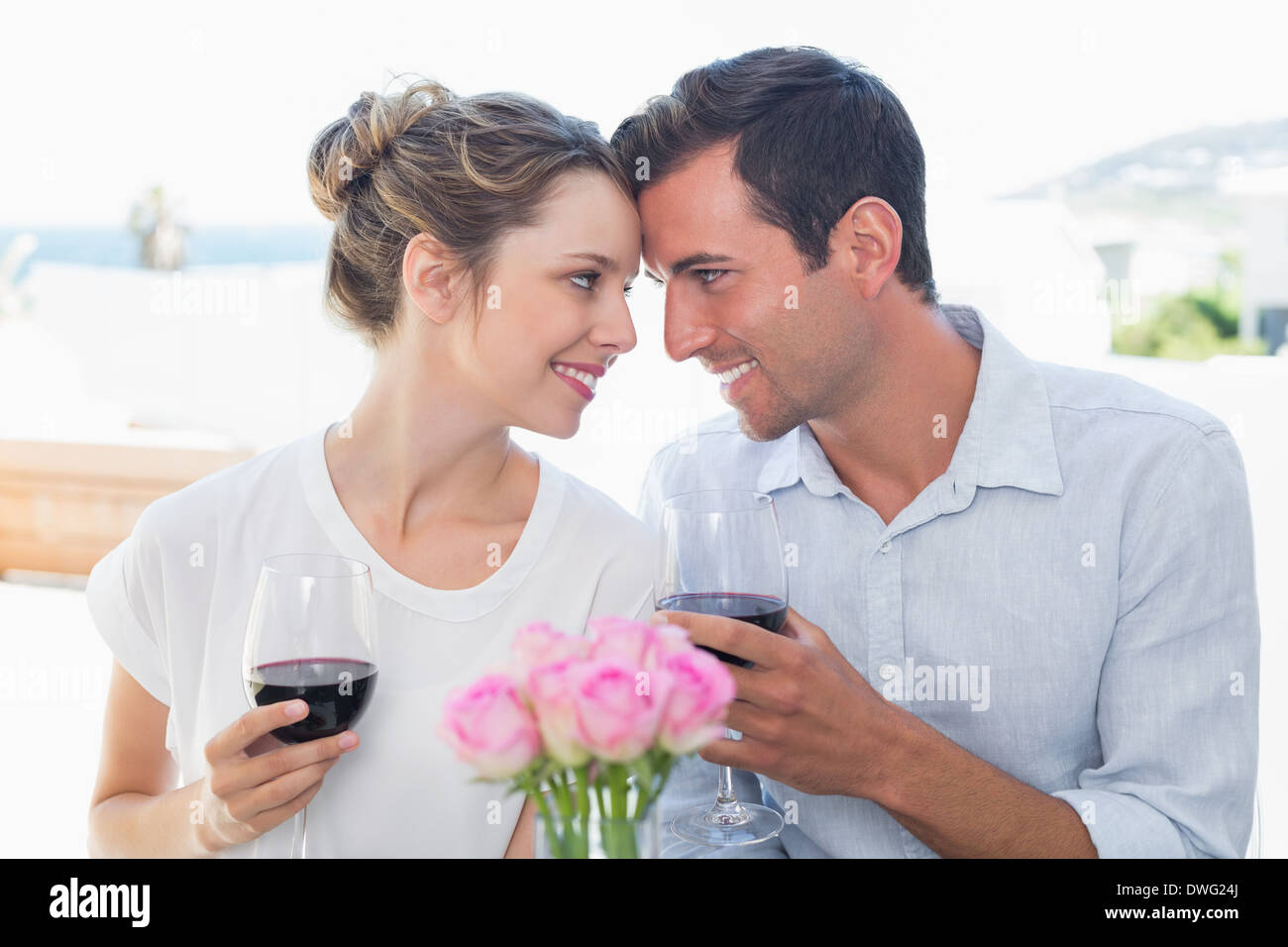 Couple with wine glasses looking at each other Stock Photo - Alamy
