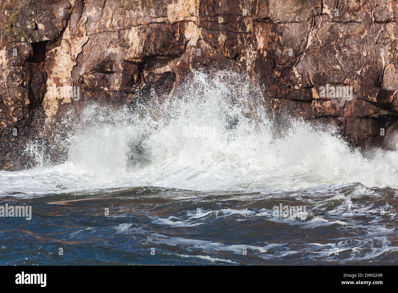 coastal rock. Waves hitting rock face. North east Scottish coastline UK ...