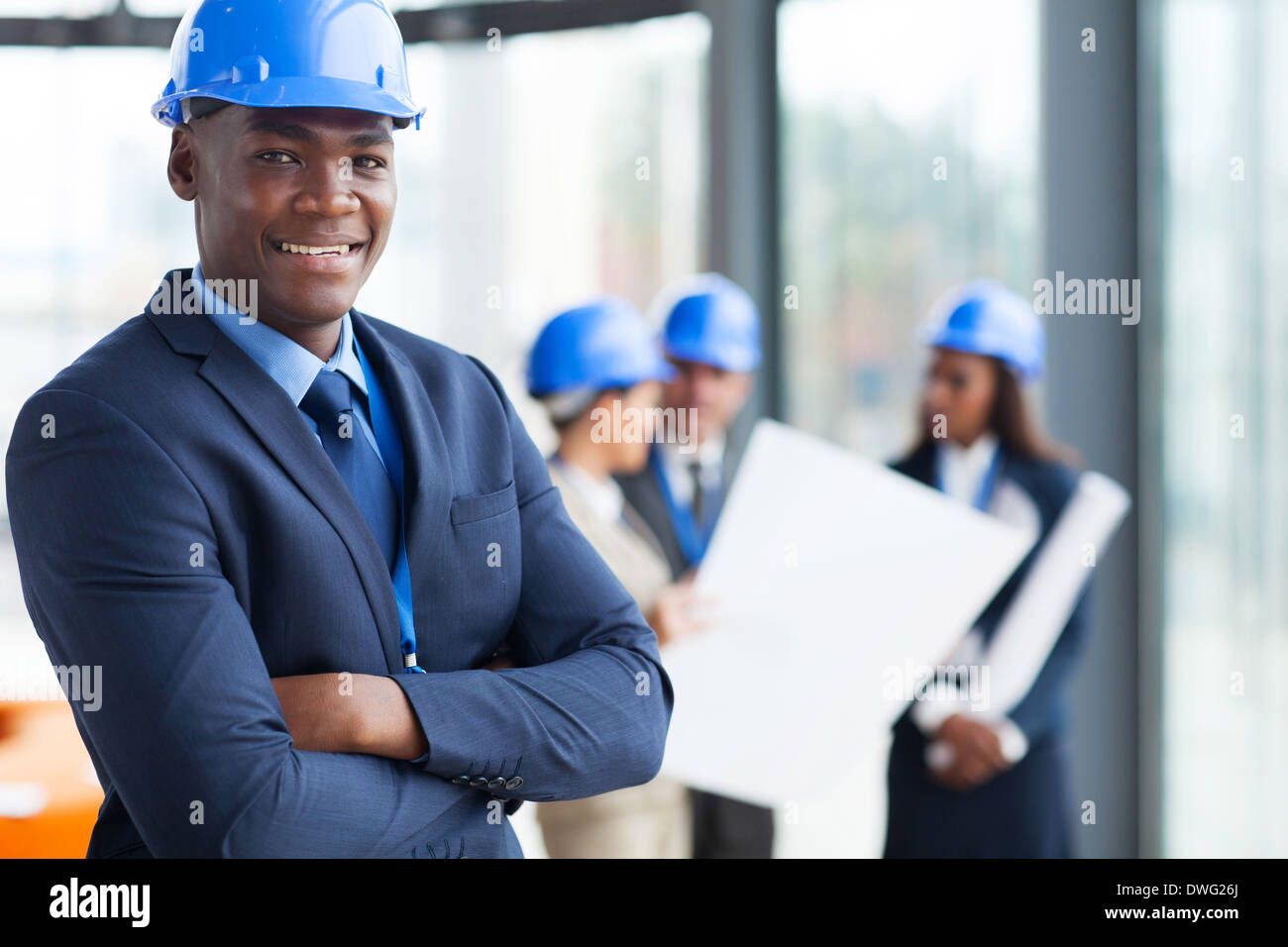 African male construction manager with arms folded Stock Photo - Alamy