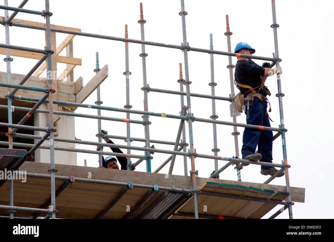 A construction worker working with pipes on a new building Stock Photo ...