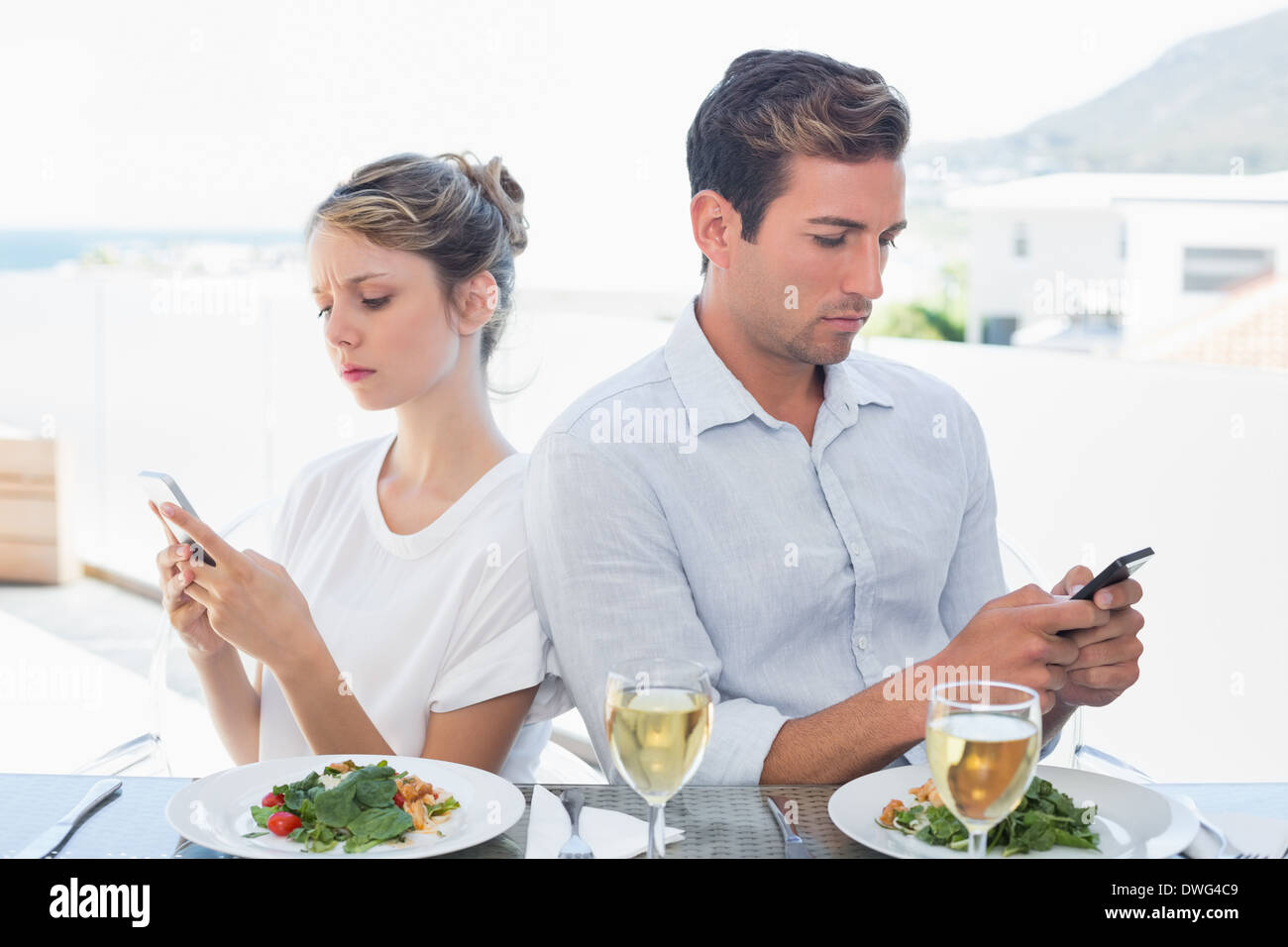 Couple table texting hi-res stock photography and images - Alamy
