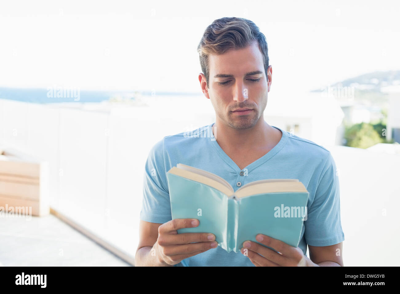 Concentrated man reading book Stock Photo - Alamy