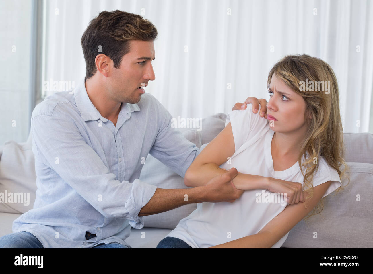 Sad looking couple in living room hi-res stock photography and images ...